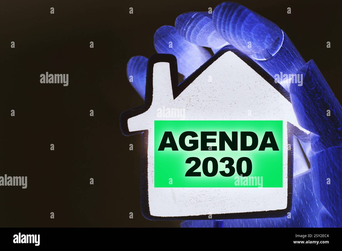 Robot hand with a house and the word "Agenda 2030" concept of ...