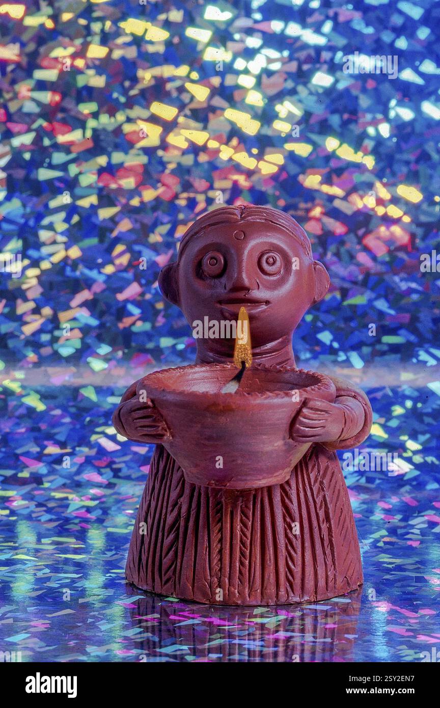 Terracotta woman statue holding diya diwali festival, India, Asia Stock ...