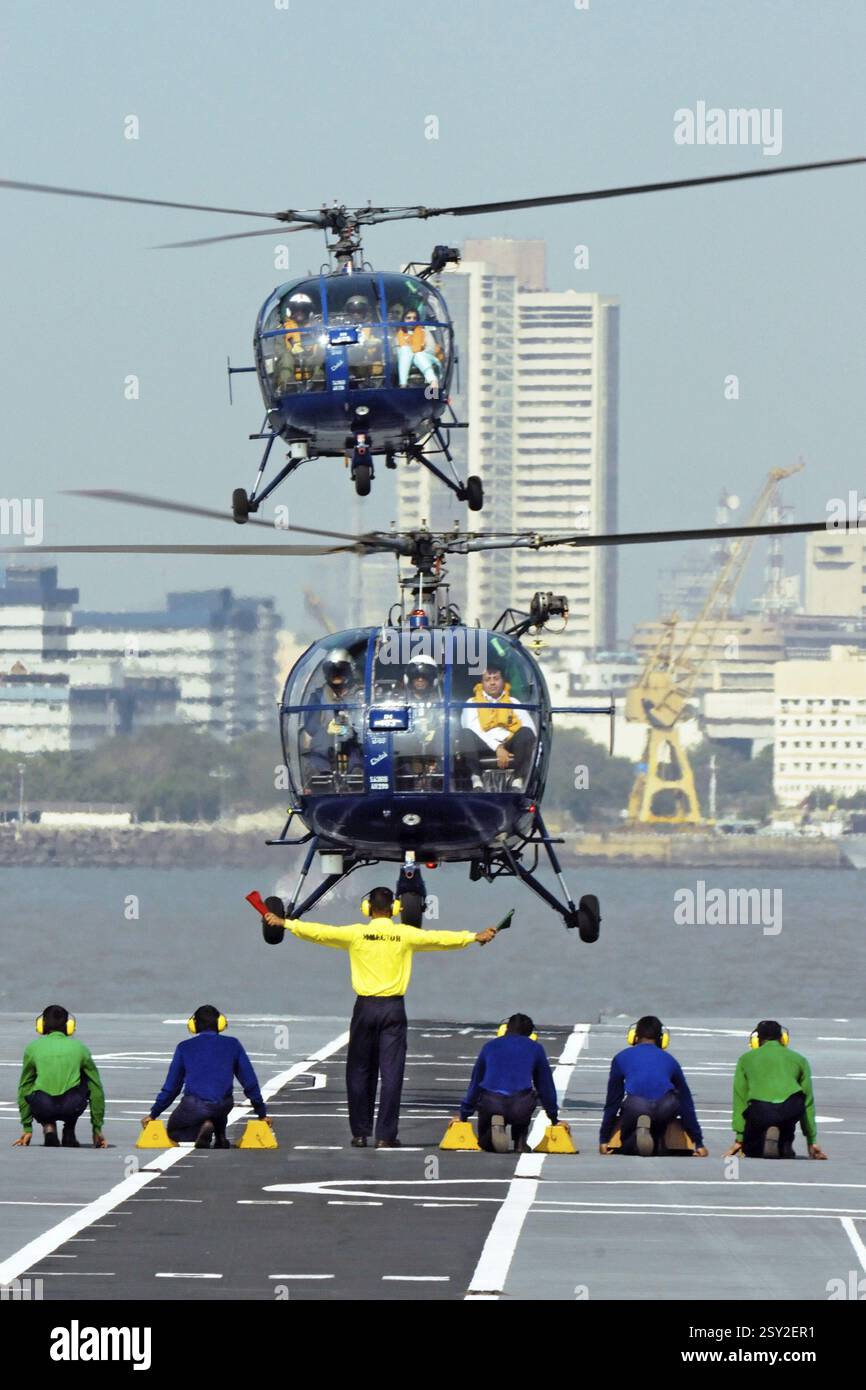 Runway controller of indian navy guide chetak helicopter landing deck ...
