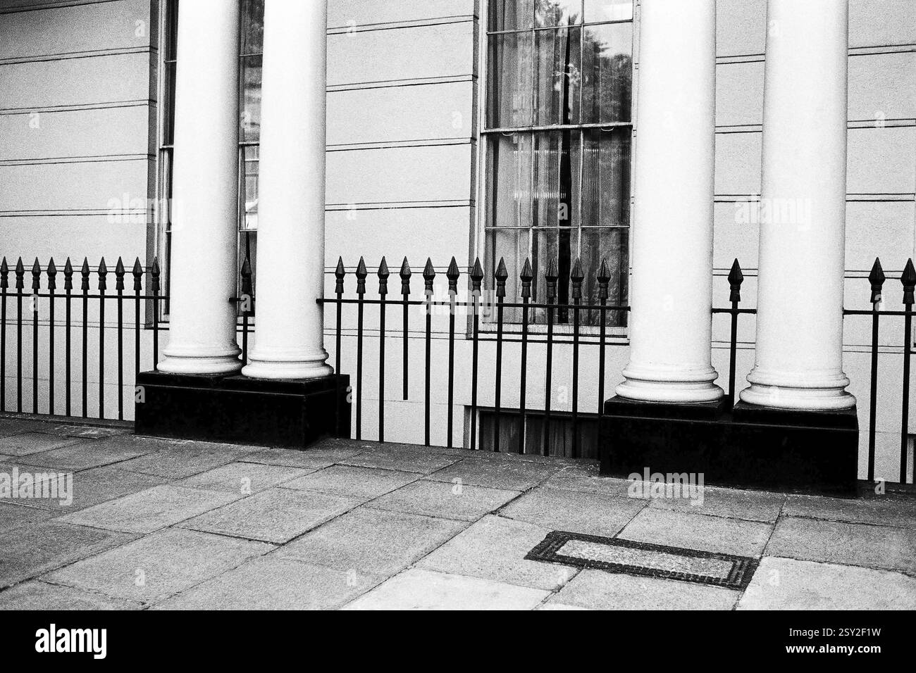 Pavement showing fence and pillars London England United Kingdom UK ...