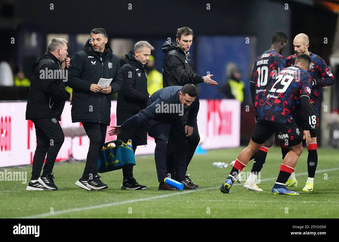 Rangers interim head coach Barry Ferguson (centre) throws water bottles ...