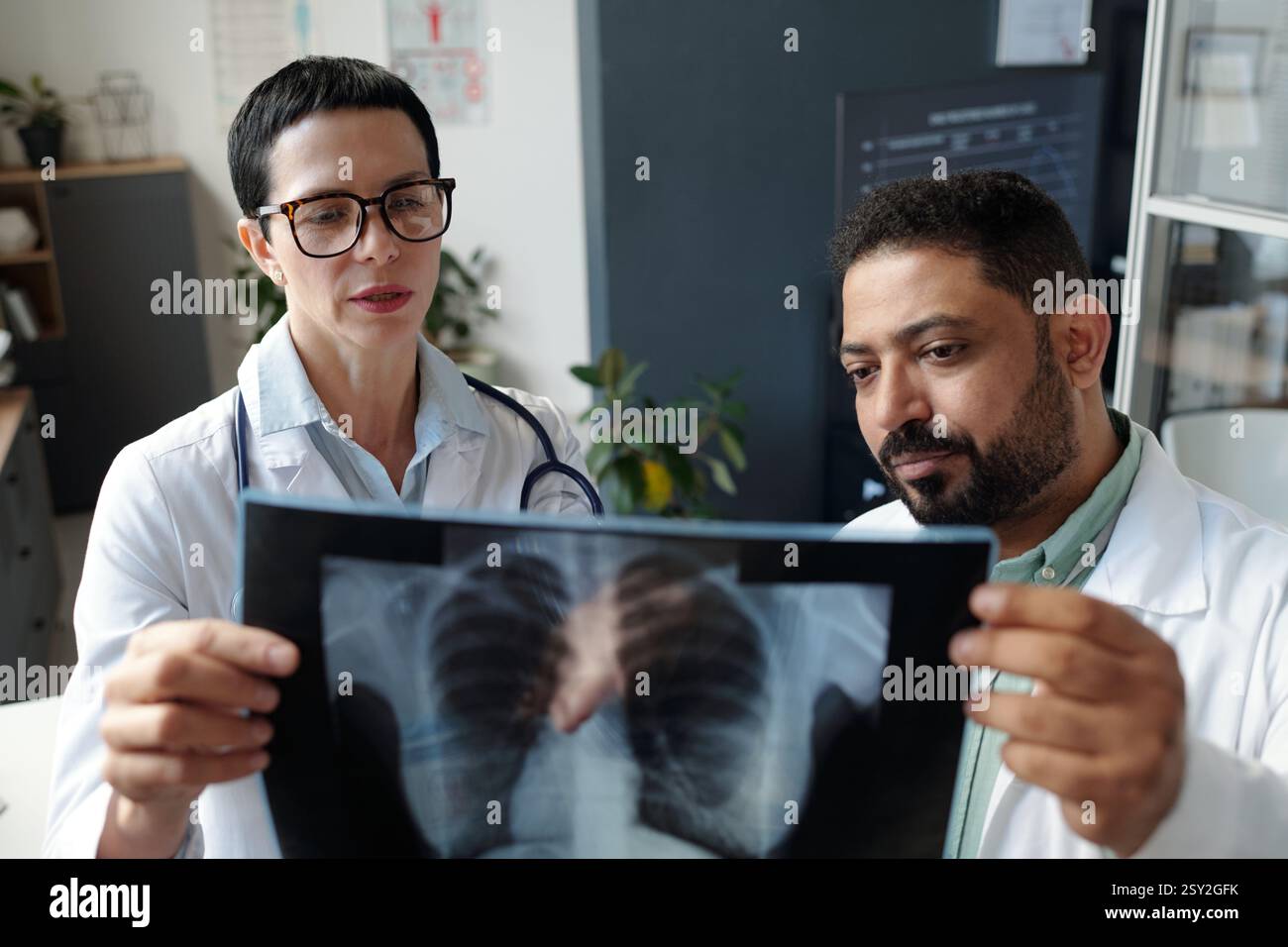 Two Doctors Looking at Chest X Ray Images in Clinic Office Discussing ...