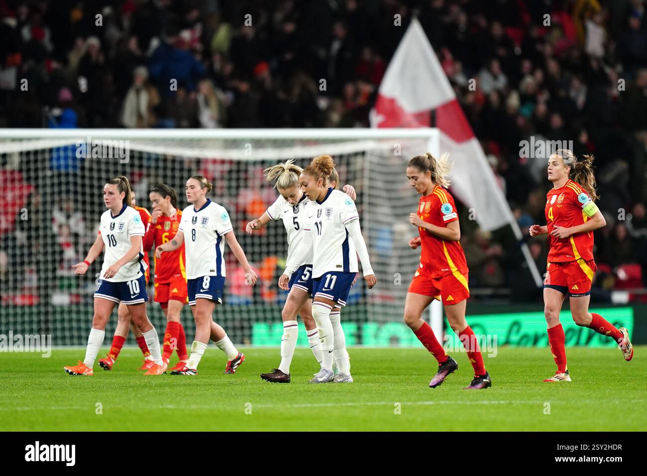 England and Spain players walk toward the dugout following the end of ...