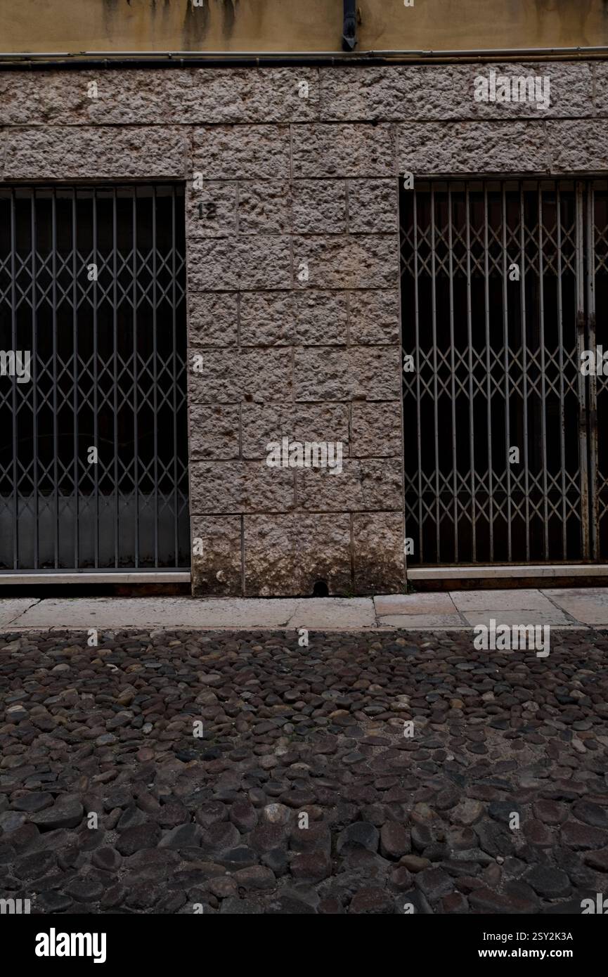 Shop windows blocked by shutters in the facade of a building in a ...