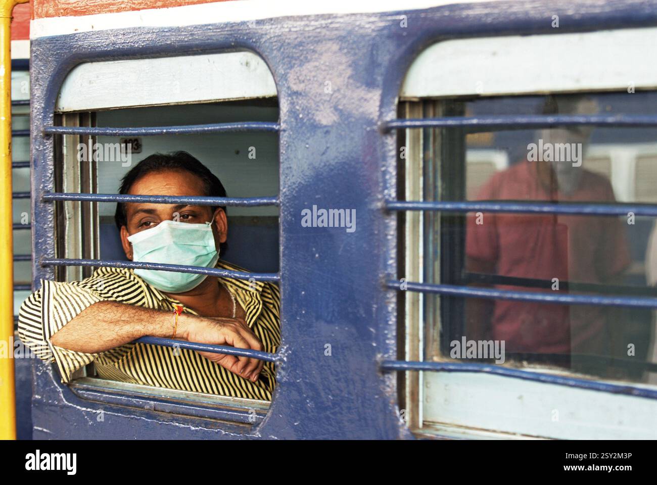 Commuter covered face with mask protection from swine flu travelling in ...