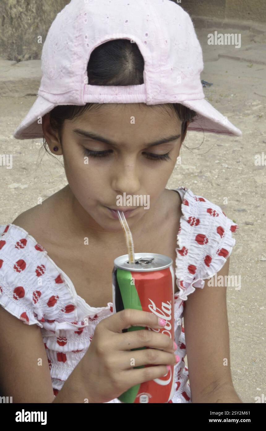 Girl taking sip of Cocacola Jodhpur Rajasthan India Asia MR#704 Stock ...
