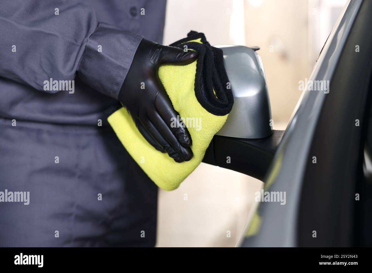 Person cleaning side mirror yellow hi-res stock photography and images ...