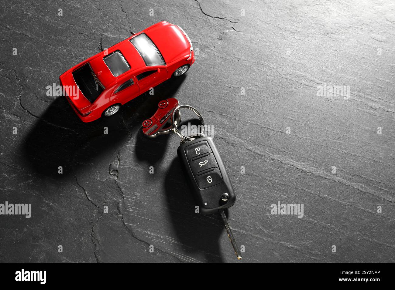Car key and model on grey background. Buying auto Stock Photo - Alamy