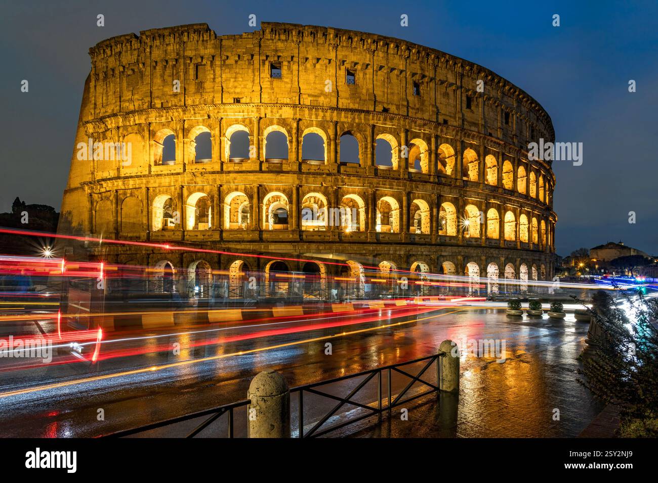 The famous Colosseum with traffic lights running around him. Photo ...