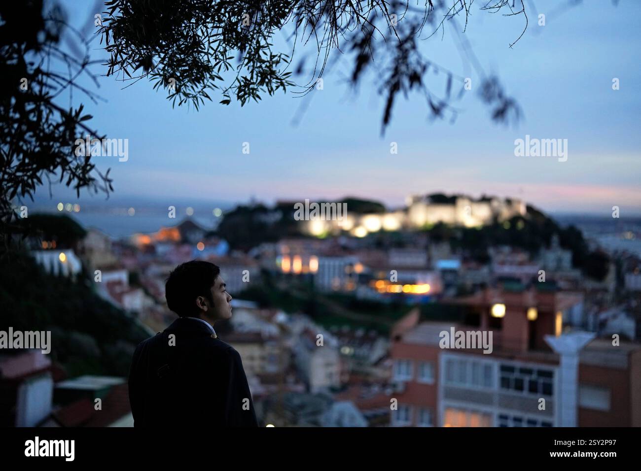 A young man look at the view from the Our Lady of the Hill viewpoint ...
