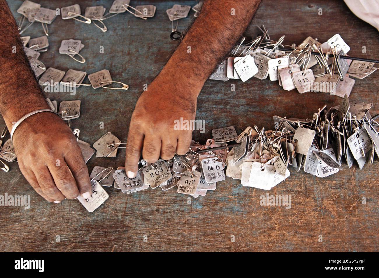 Cloak room incharge shows badges Nanded, Maharashtra, India, Asia Stock ...