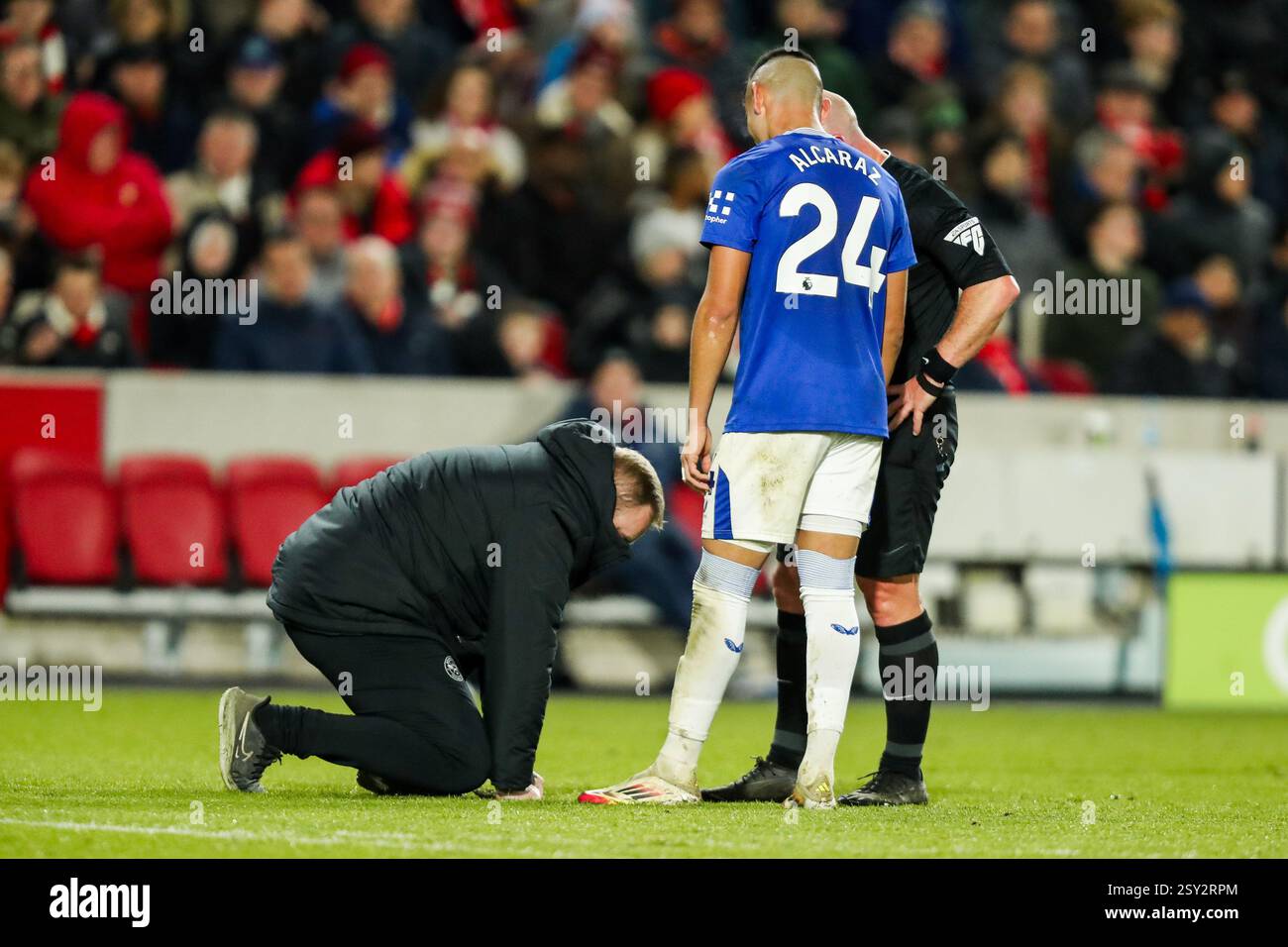 Brentford ground staff fix the pitch during the Premier League match ...