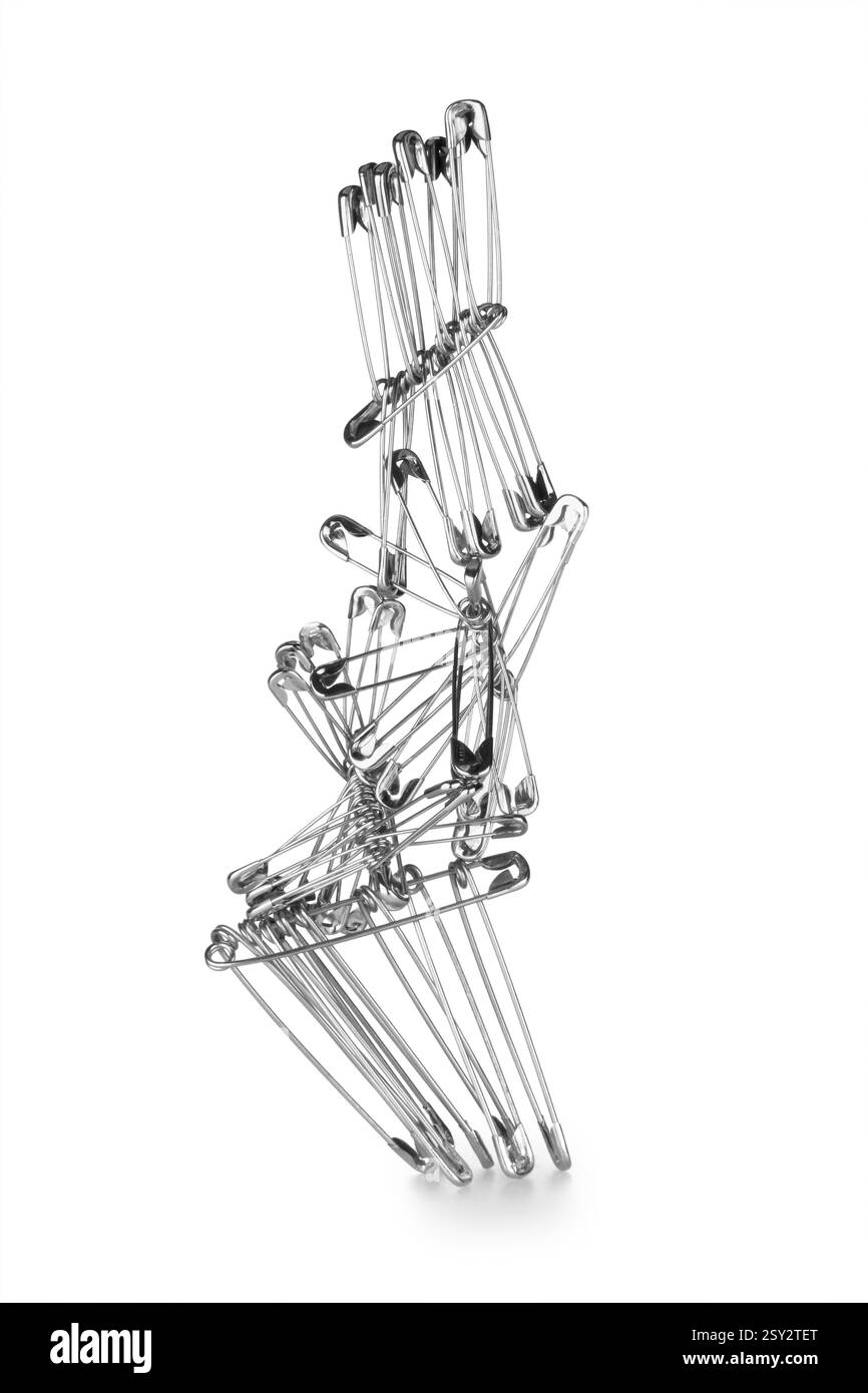 Balancing of safety pin, india, asia Stock Photo - Alamy