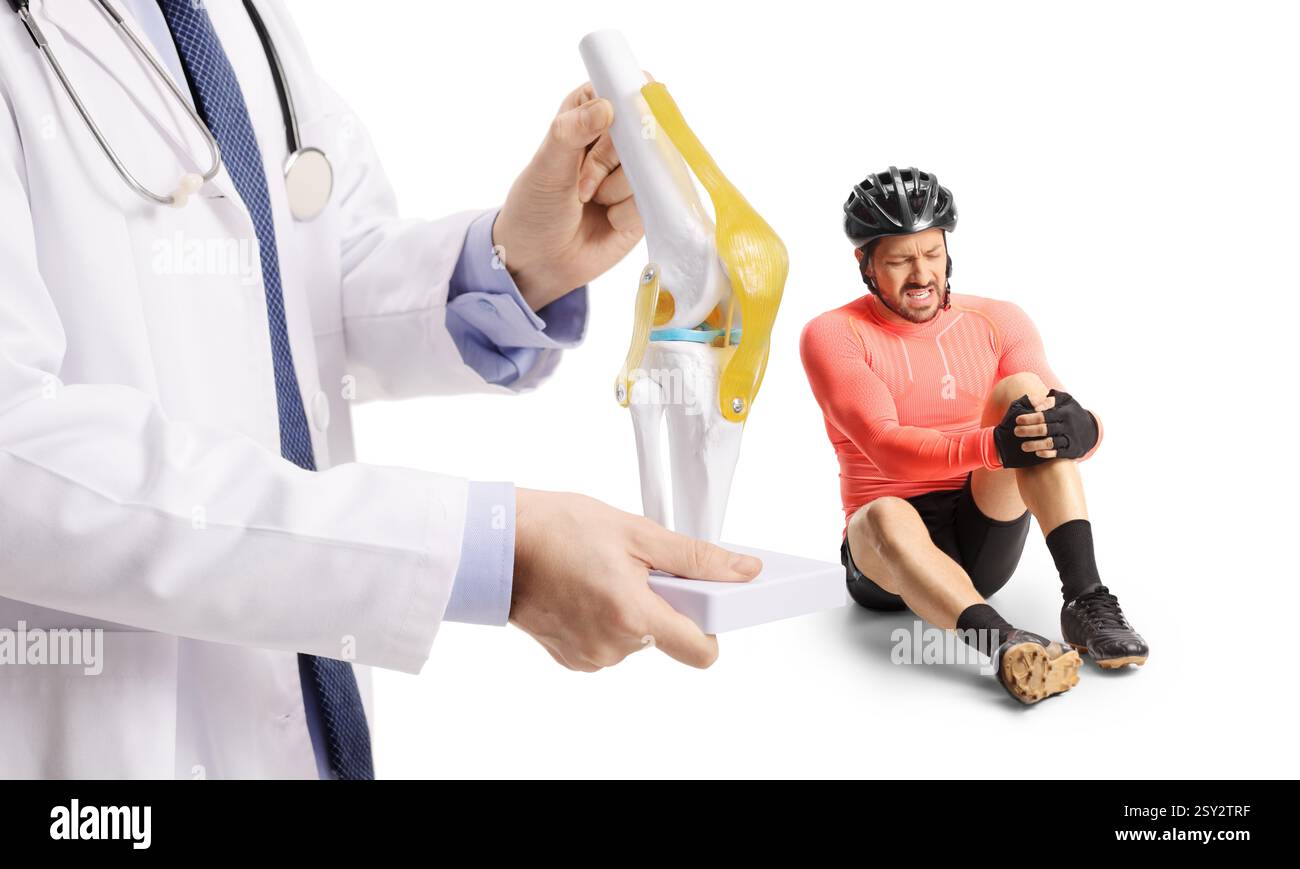 Injured cyclist sitting on the ground and holding his painful knee ...