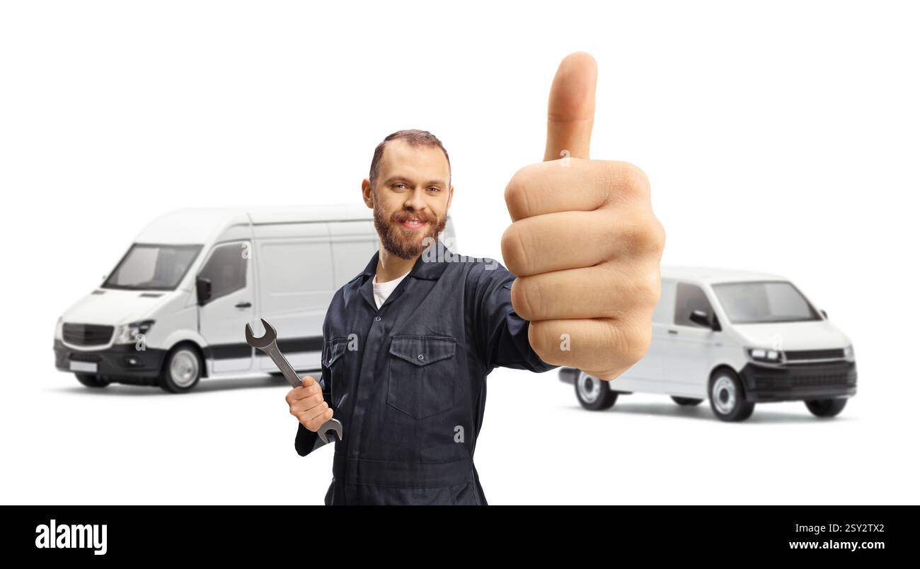 Van mechanic posing with a wrench in his hand and gesturing thumbs up ...