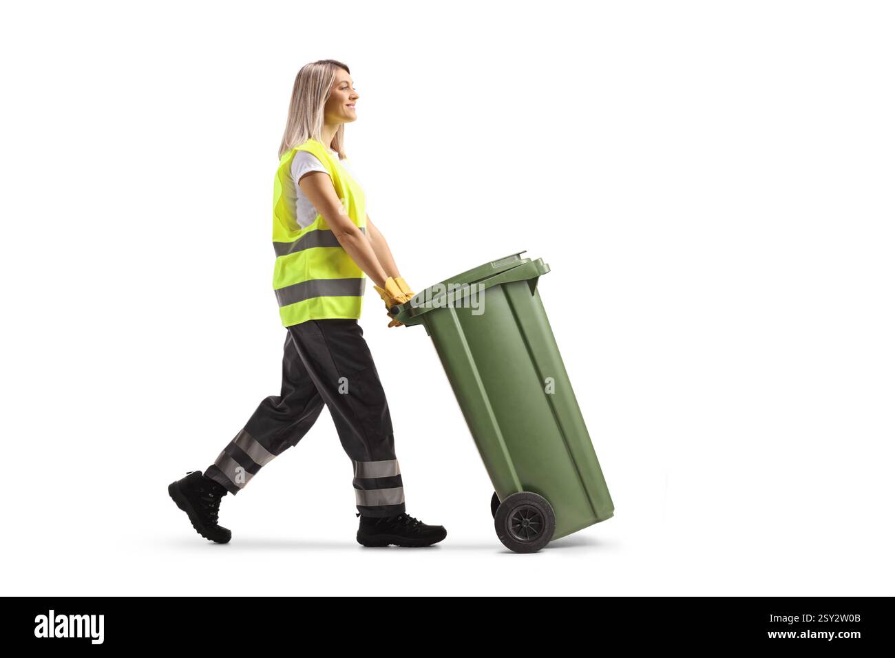 Full length profile shot of a female waste collector pulling a bin ...