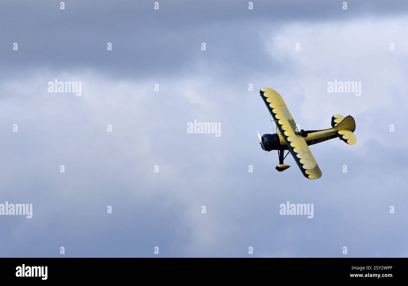 Vintage Waco UPF-7 biplane in flight against clouds Stock Photo - Alamy