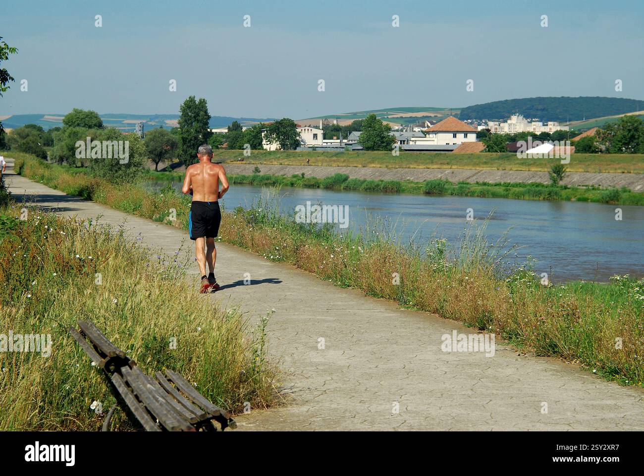 Mature man running on the banks of the Mures river Stock Photo - Alamy