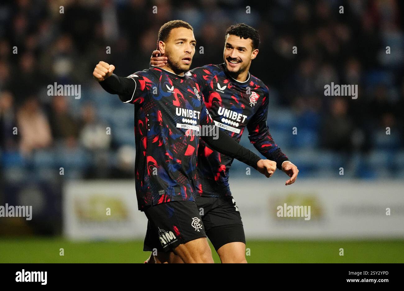 Rangers' Cyriel Dessers (left) celebrates scoring their side's third ...