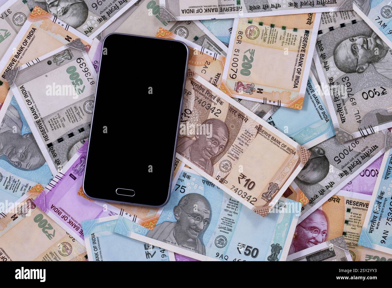 Mobile smart phone and indian rupee notes, digital money, fin-tech ...