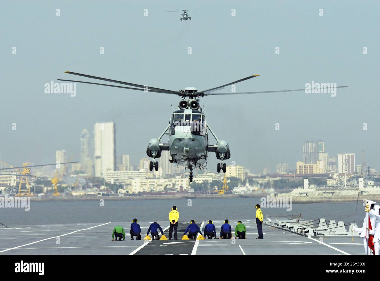 Runway controller of indian navy guide MI 18 helicopter landing on the ...