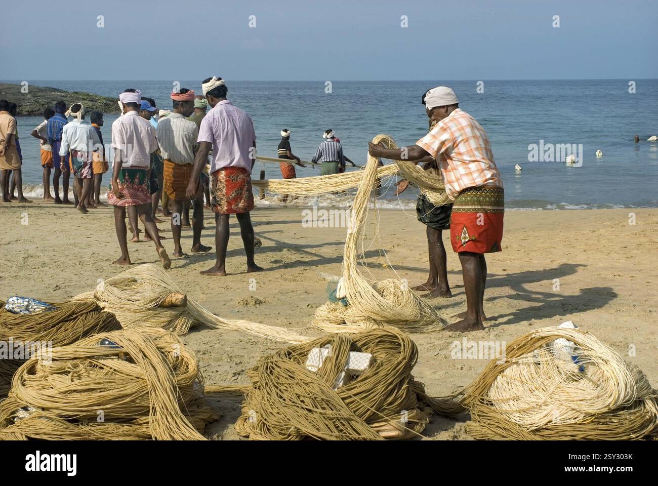 Fishermen pulling dragnets Kovalam beach Kerala India Stock Photo - Alamy