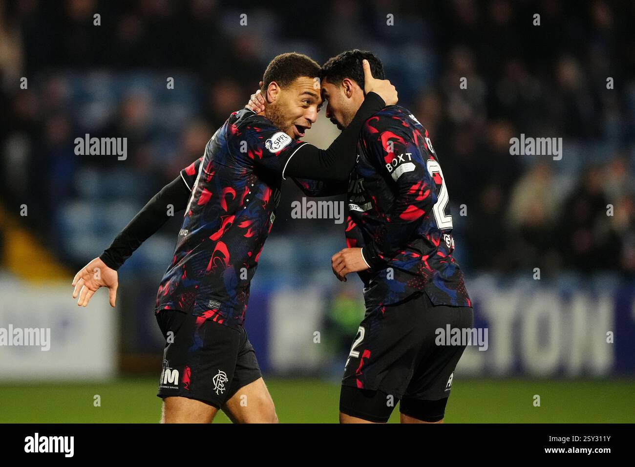 Rangers' Cyriel Dessers (left) celebrates scoring their side's third ...