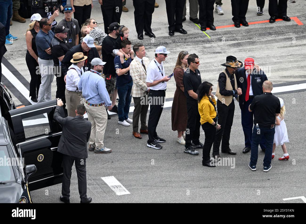 President Donald Trump, right, gets a hug from Richard Petty on pit ...