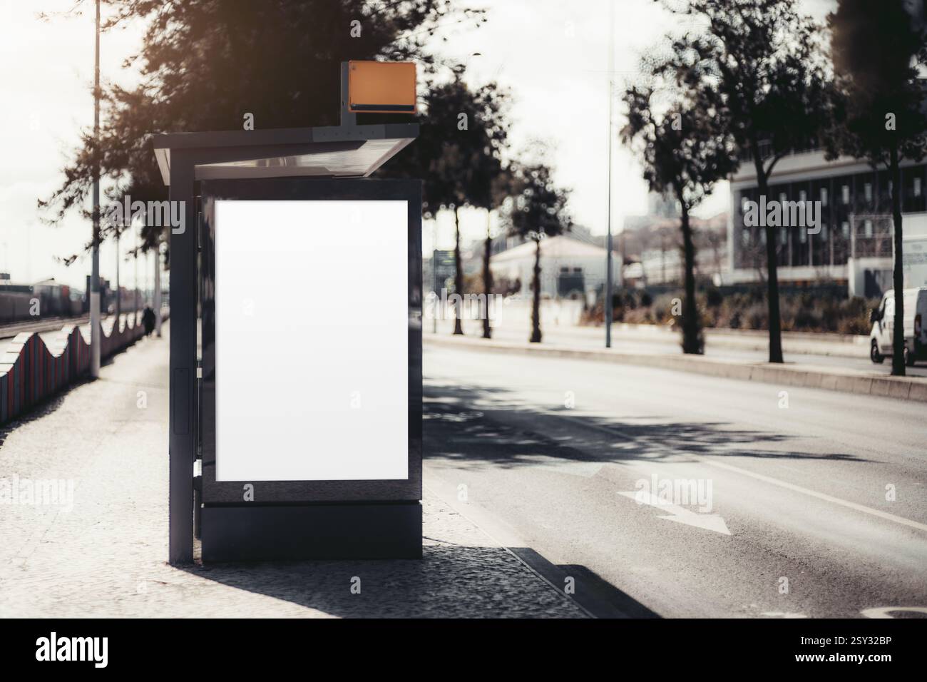 Blank bus stop billboard mockup on urban street. Sunlit advertising ...