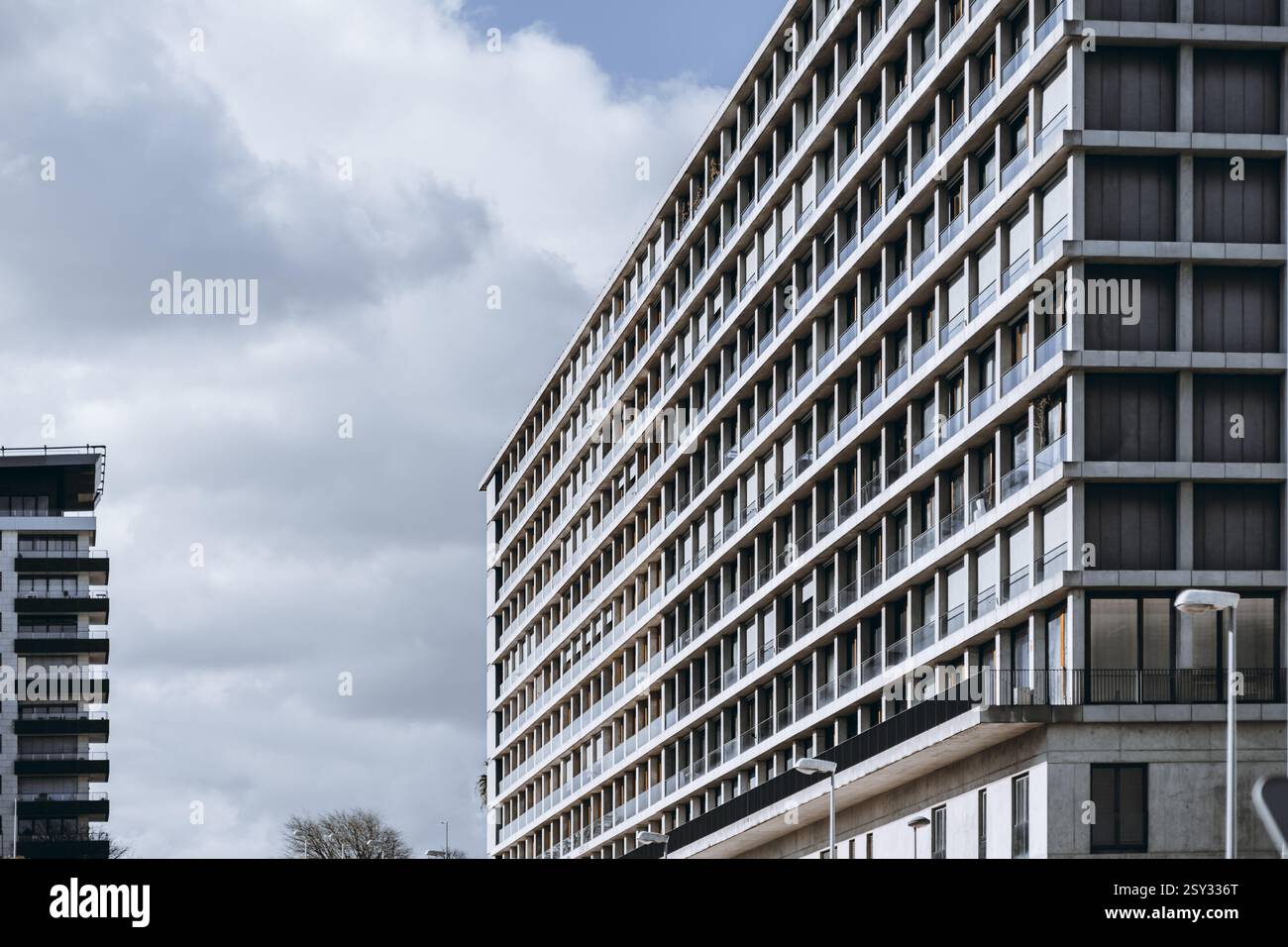 A telephoto shot of a modern concrete and glass office building with ...