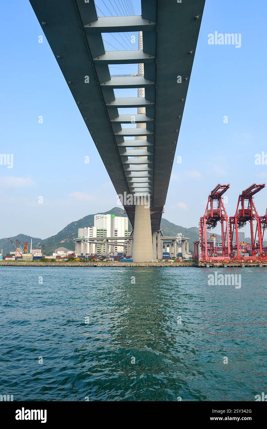 View of a bridge's underside over water, with a central support column ...