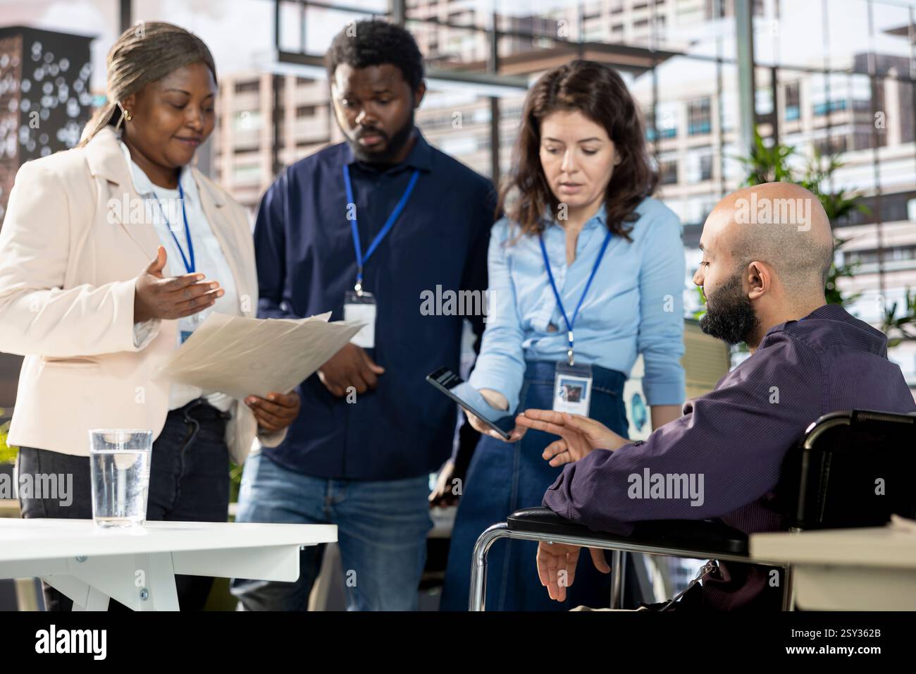 Manager with disability meeting with his diverse employees group ...
