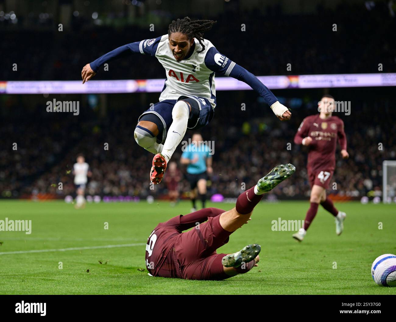 London, UK. 26th Feb, 2025. Djed Spence (Spurs) jumps over Abdukodir ...