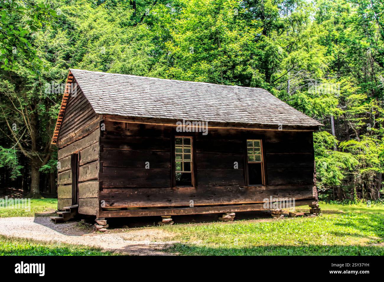 Small, old-fashioned house with a slanted roof. The roof is made of ...