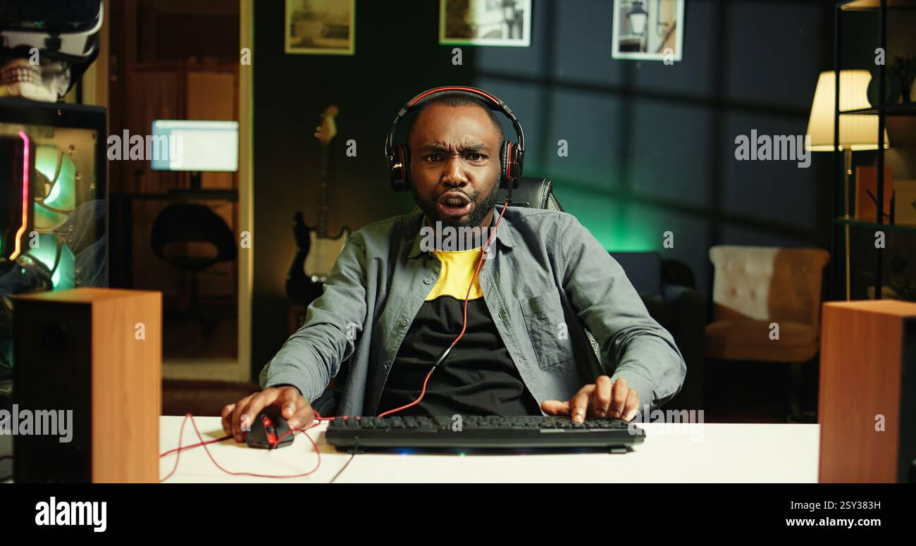 Gamer wearing headphones face palming himself in frustration after ...