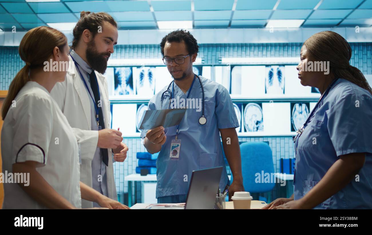 Hospital experts review x rays and discuss treatment plan strategy in ...