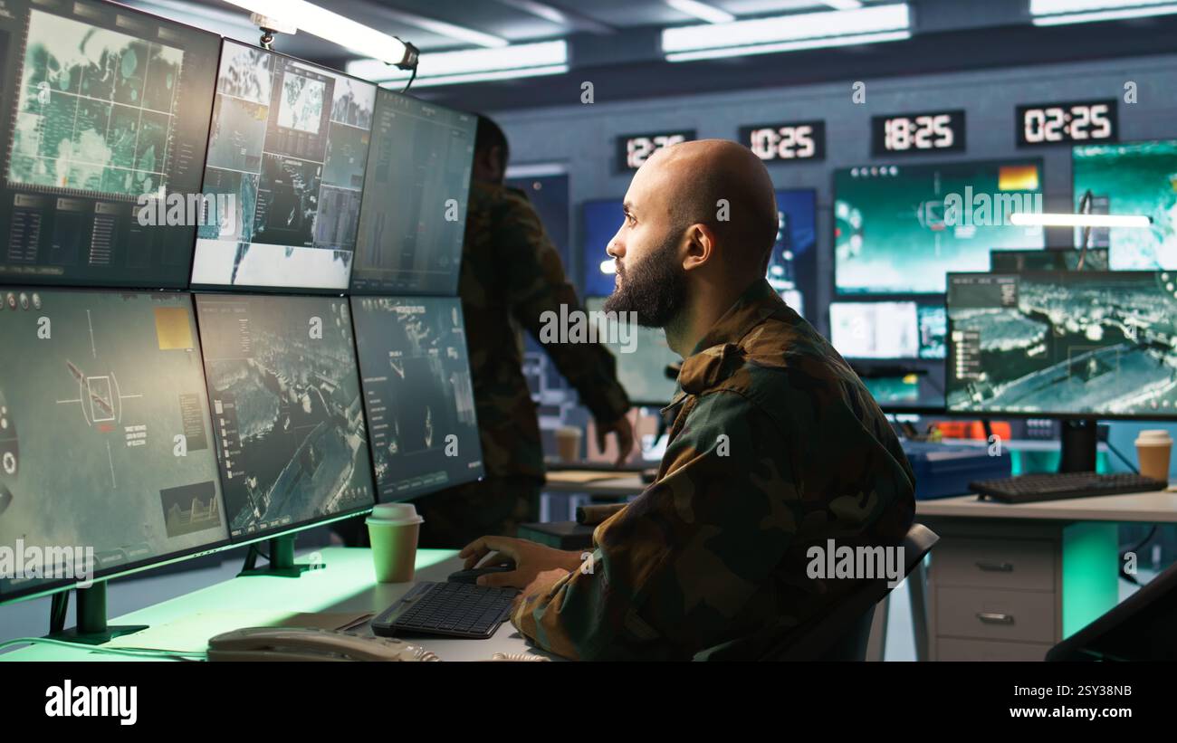 Man looking at screens in military HQ base housing operational missile ...