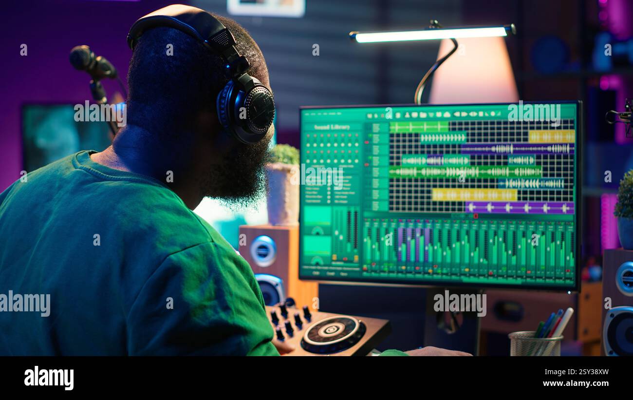 Young musician twisting knobs mixing hi-res stock photography and ...