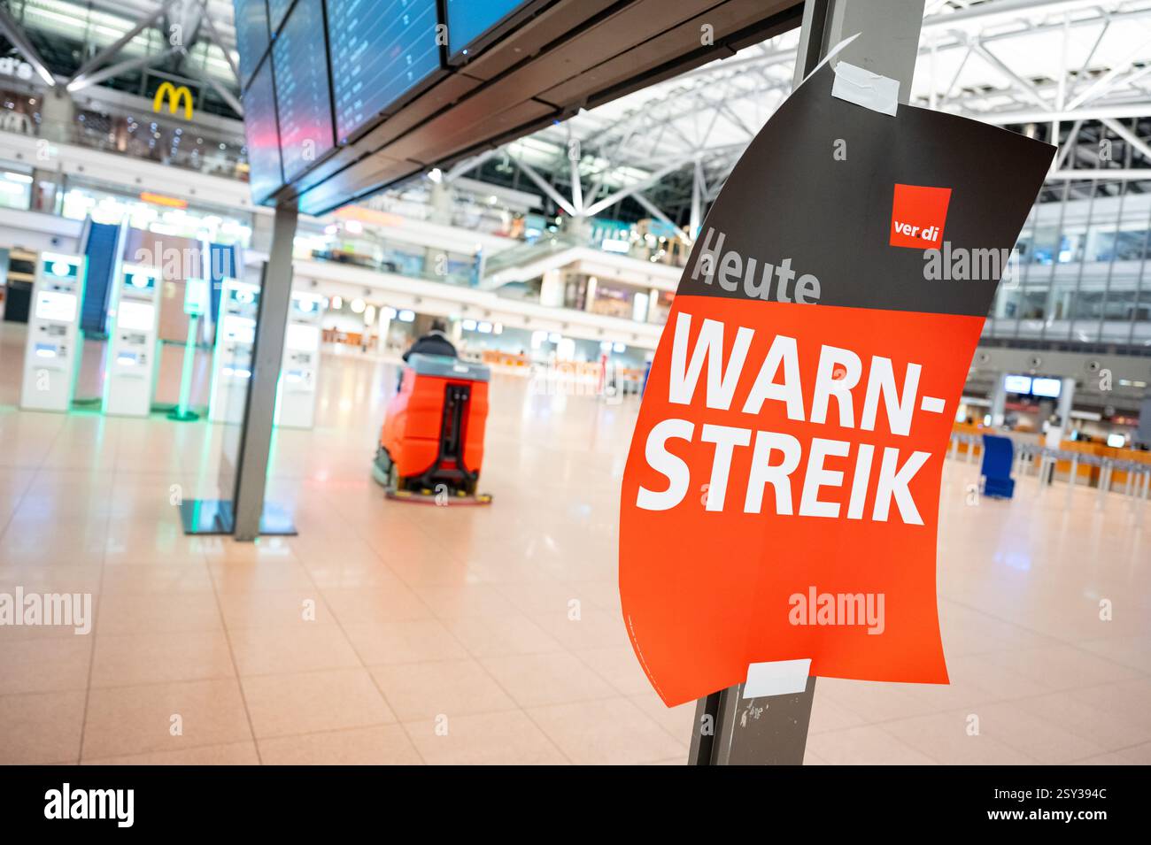 26 February 2025, Hamburg: "Warning strike today" is written on a verdi ...