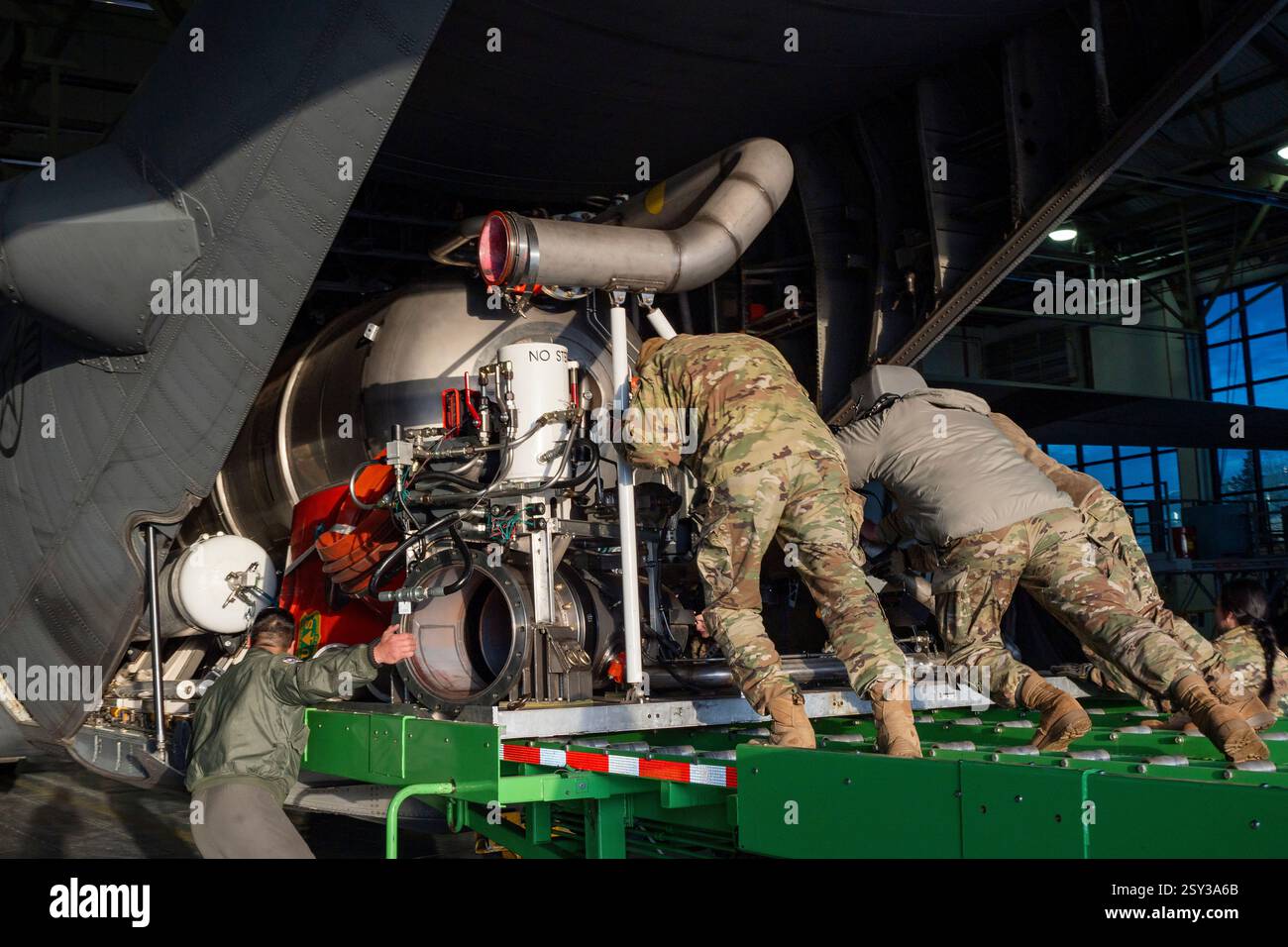 U.S. Air Force Airmen assigned to the 153rd Airlift Wing load and ...