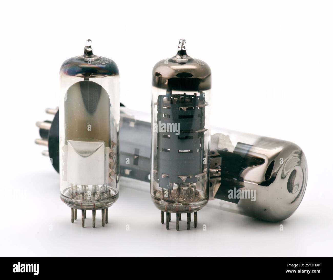 Different types of vacuum tubes are arranged stylishly on a plain ...