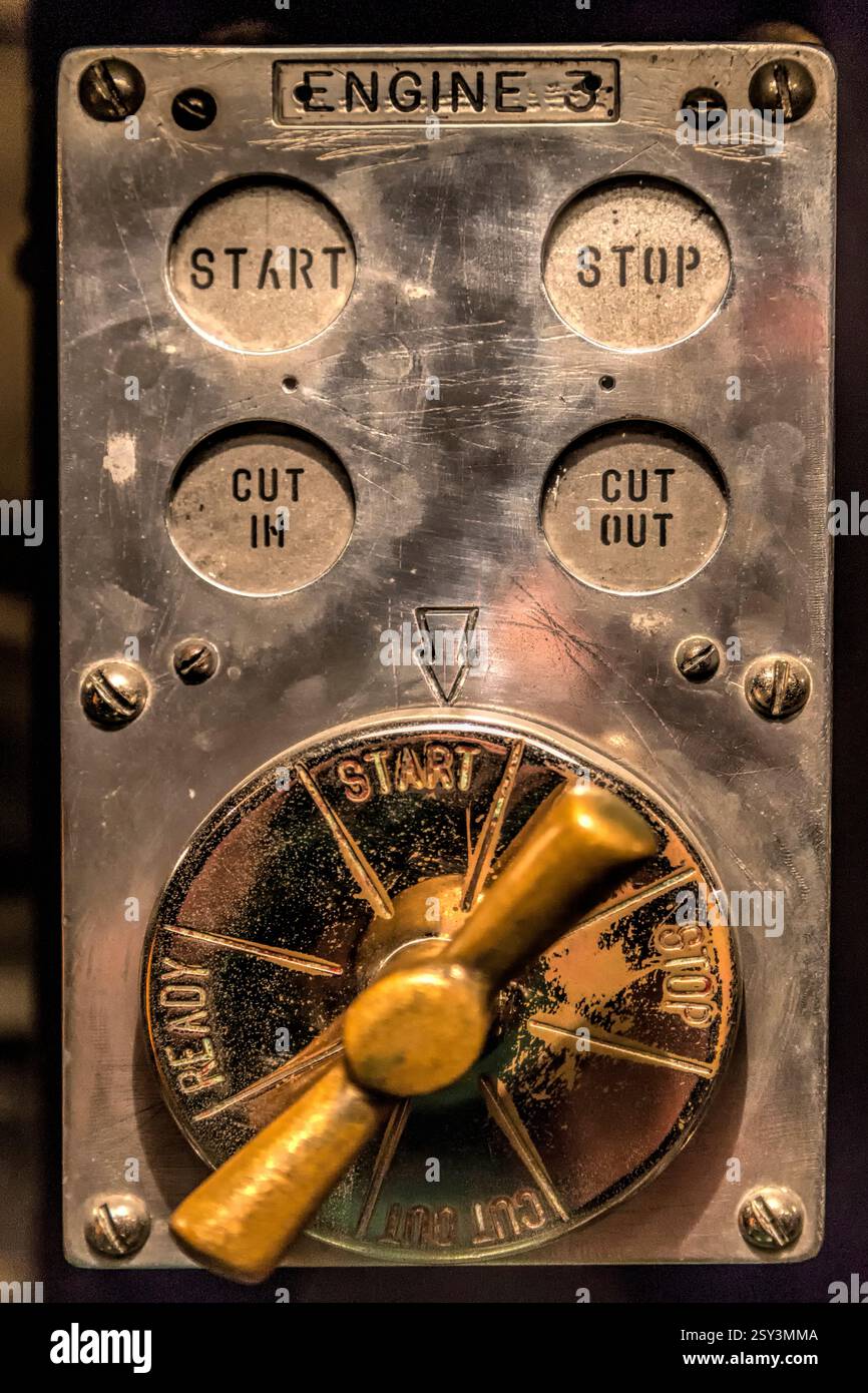 Silver and gold engine control panel with four buttons. The buttons are ...