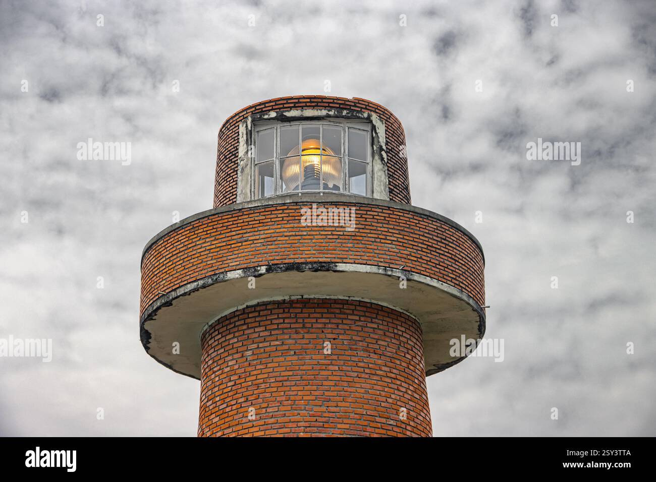 Brick lighthouse against a sky with clouds Stock Photo - Alamy