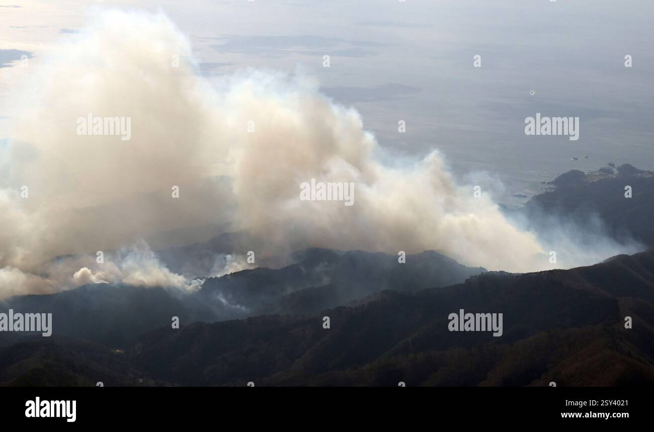An aerial photo shows a forest fire, continues to spread in Ofunato ...