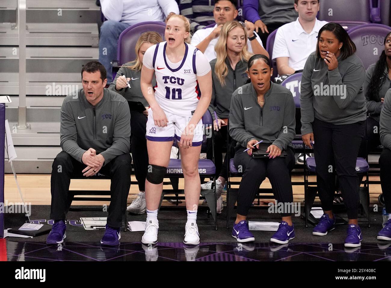 TCU guard Hailey Van Lith (10) and members of the coaching staff cheer ...
