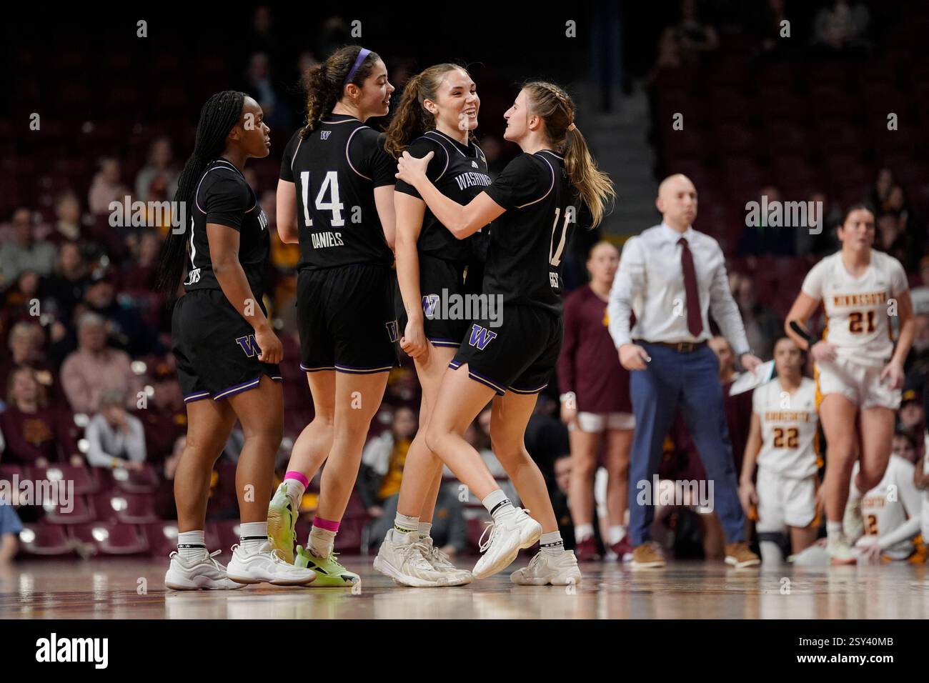 Washington guard Elle Ladine (24), middle right, celebrates with ...