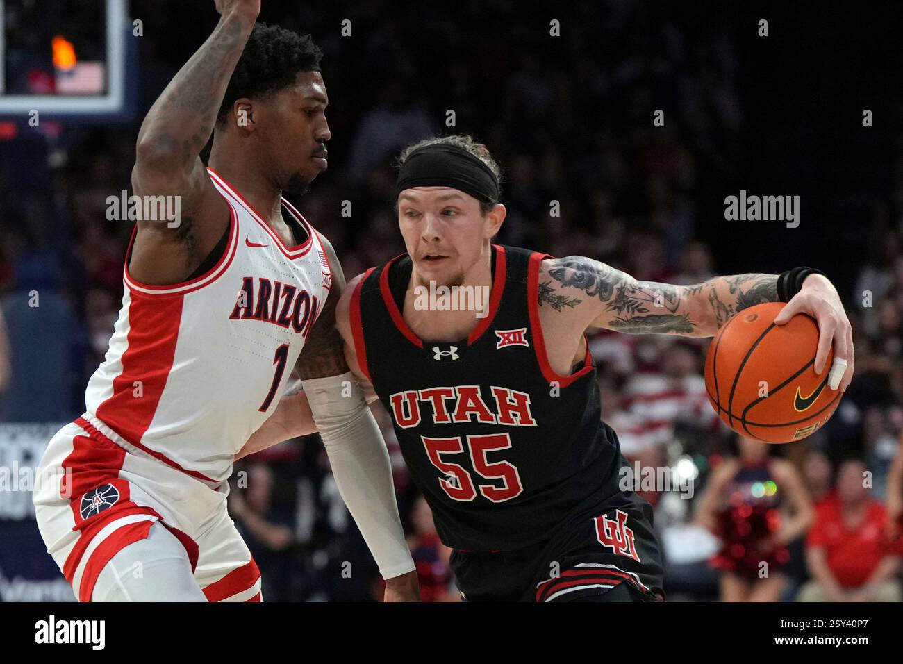 Utah guard Gabe Madsen (55) drives on Arizona guard Caleb Love during ...