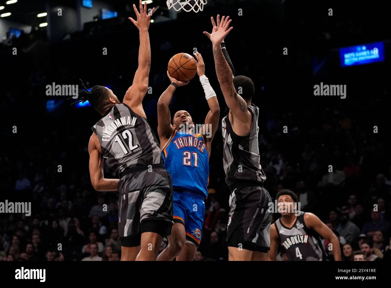 Oklahoma City Thunder's Aaron Wiggins (21) shoots over Brooklyn Nets' Tosan Evbuomwan (12) and ...