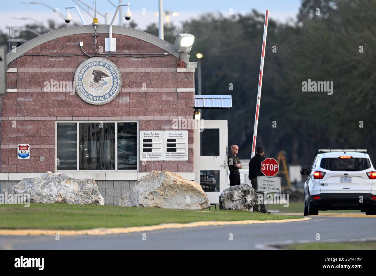 Prison officials stand outside a guardhouse in front of Federal ...