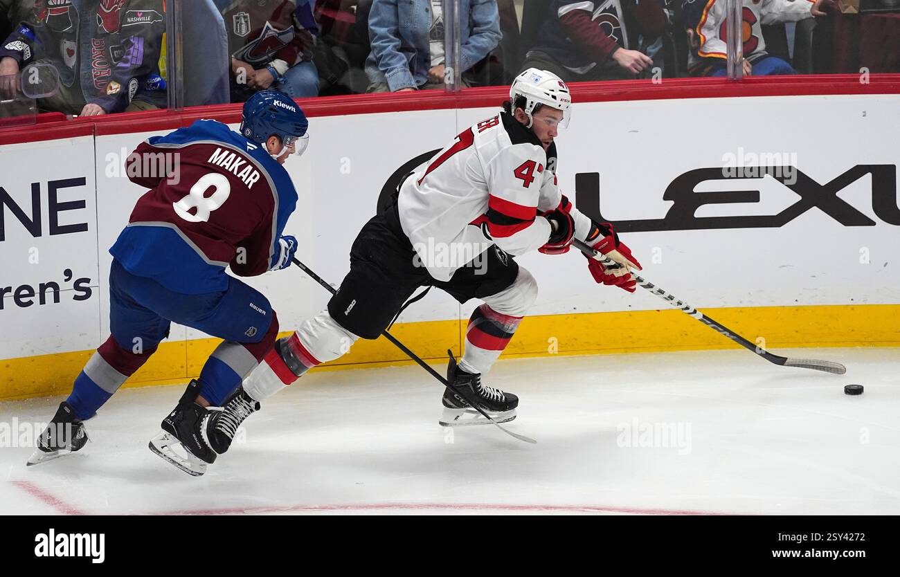 New Jersey Devils center Paul Cotter, right, collects the puck as ...